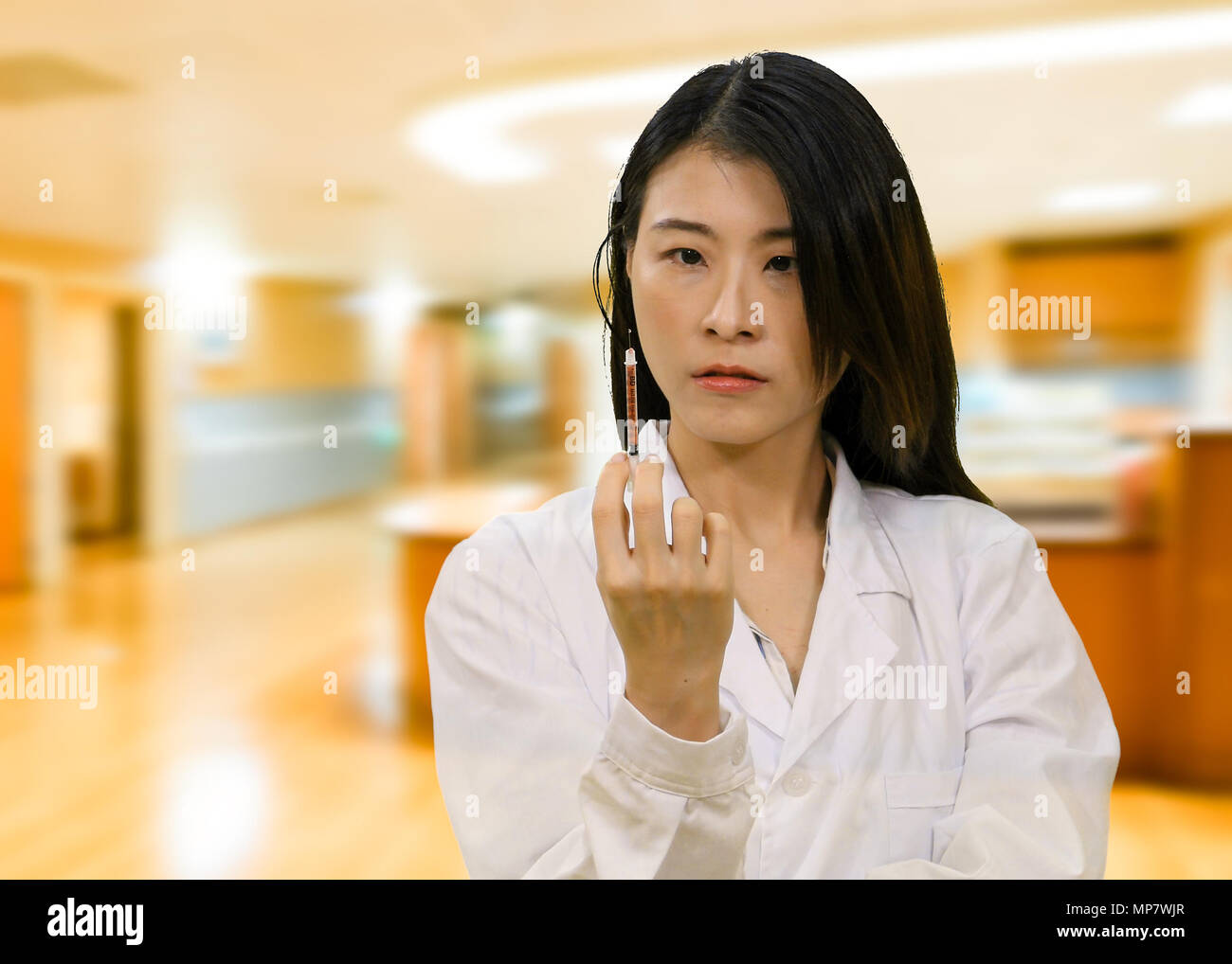 Chinese female doctor in hospital holding syringe Stock Photo - Alamy