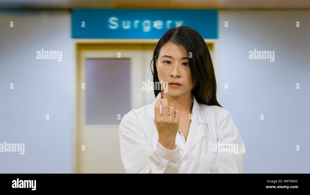 Chinese female doctor by hospital surgery holding syringe Stock Photo ...