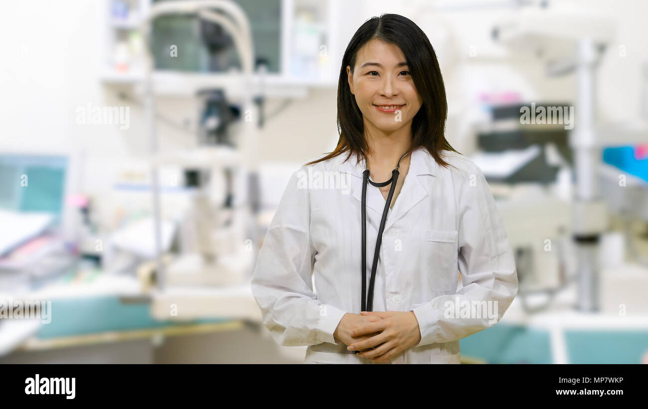 Chinese female doctor in hospital clinic looking at camera Stock Photo ...