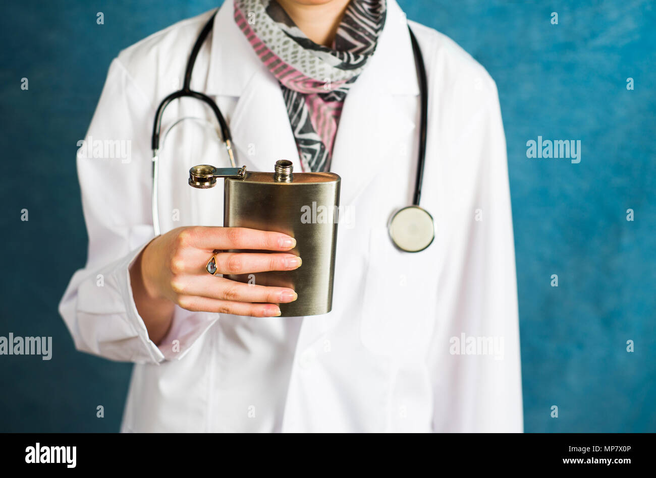 Female doctor holding a hip flask close up Stock Photo - Alamy