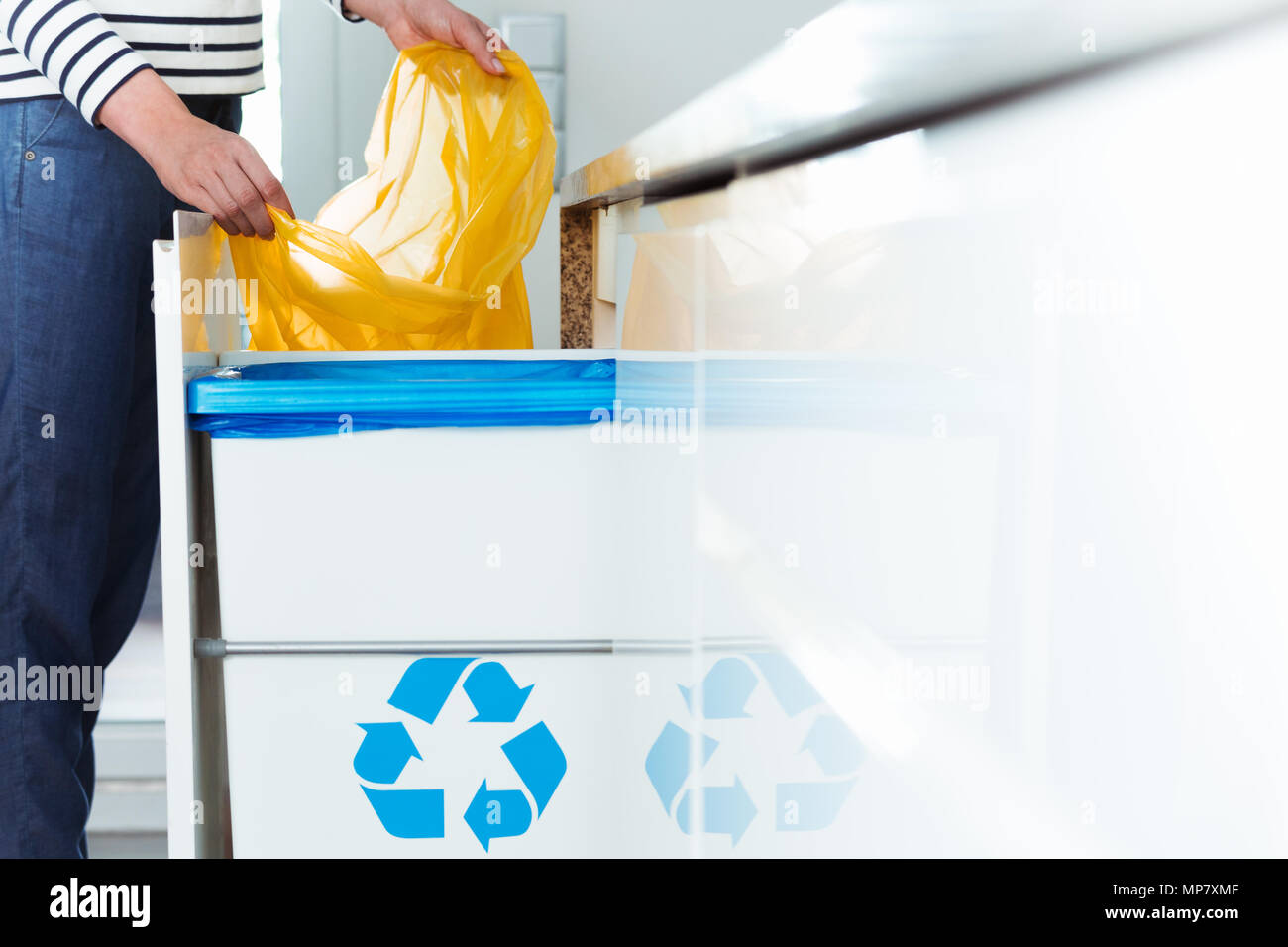 Smart person changing bin bag for recycling waste in eco friendly ...