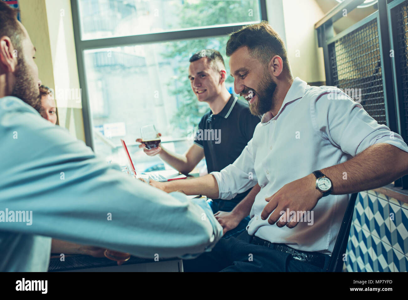 Team job while relaxing in pub Stock Photo - Alamy
