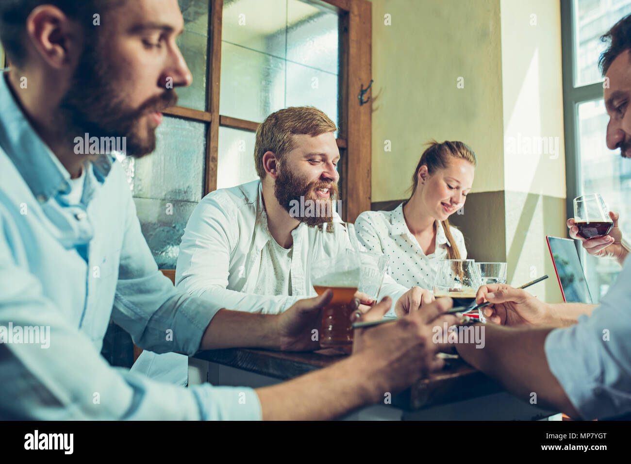 Team job while relaxing in pub Stock Photo - Alamy