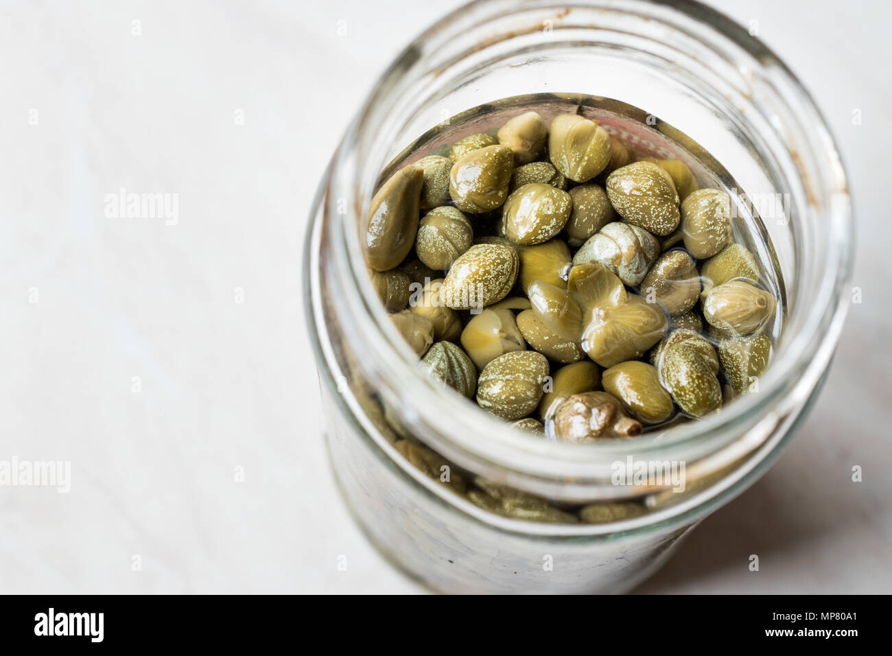 Jar of Capers in Glass Bowl. Organic Food Stock Photo - Alamy