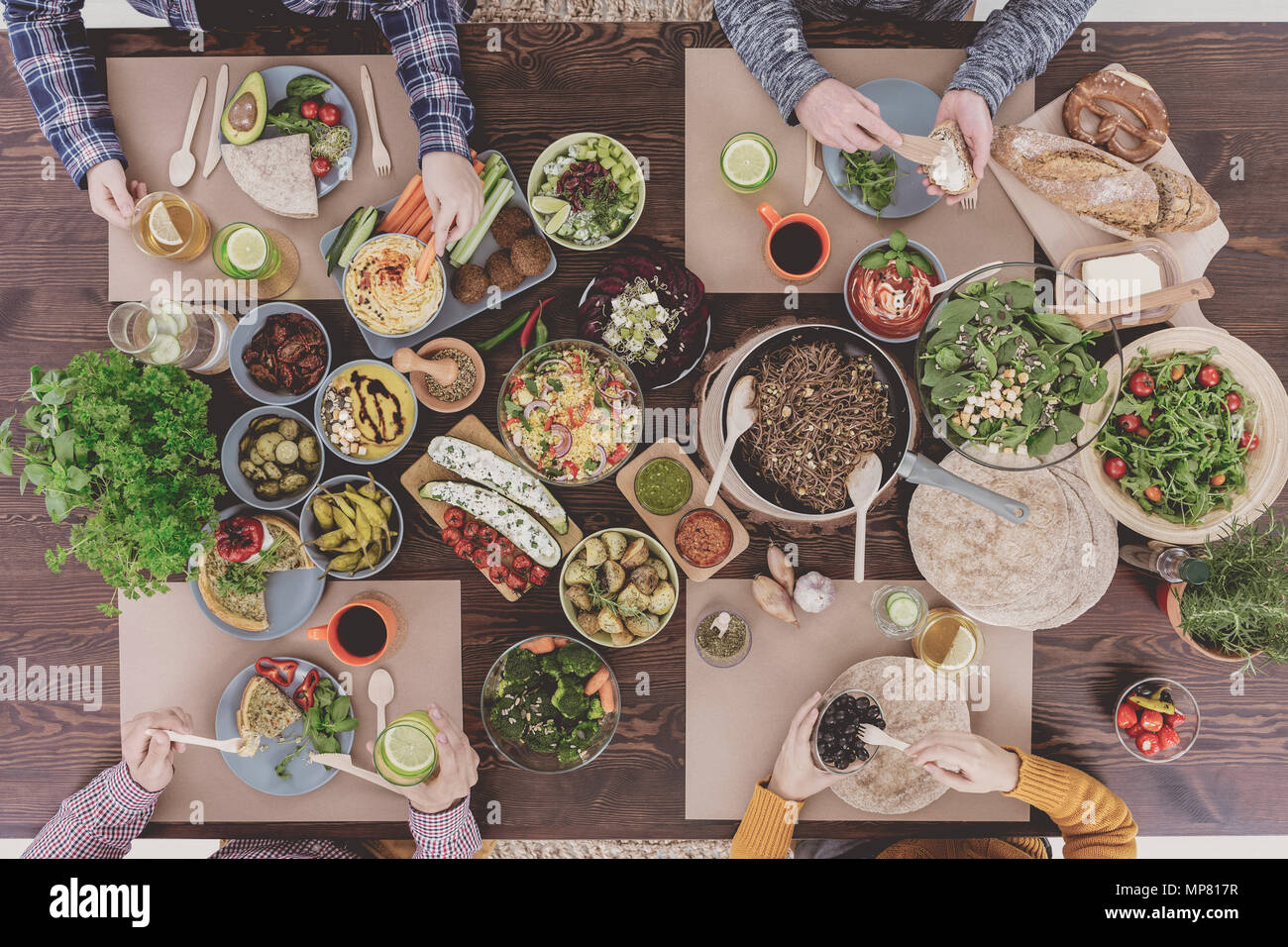 Top view of people eating vegetarian dinner Stock Photo - Alamy