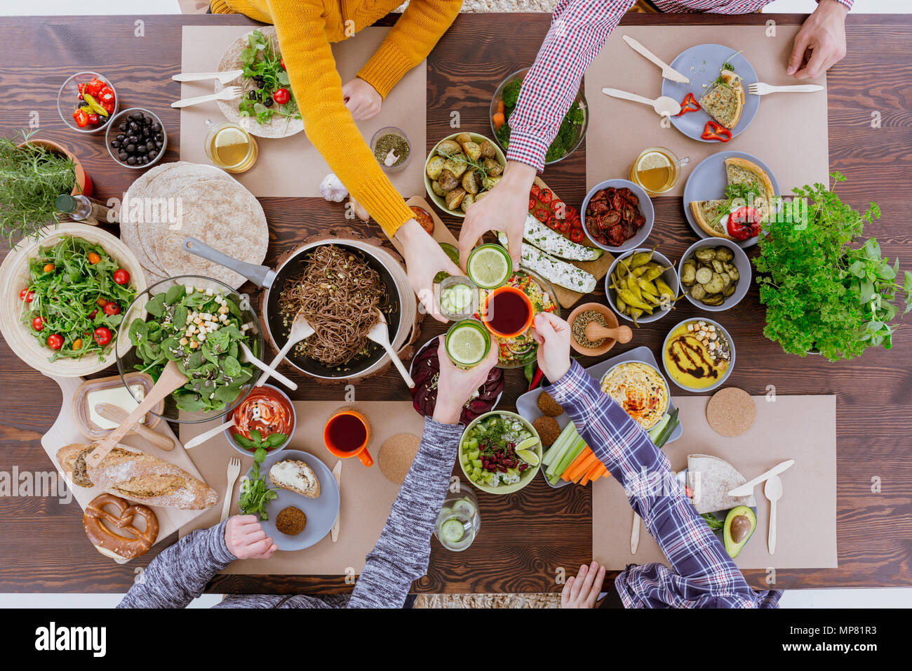 People sitting at rustic table, eating healthy food Stock Photo - Alamy