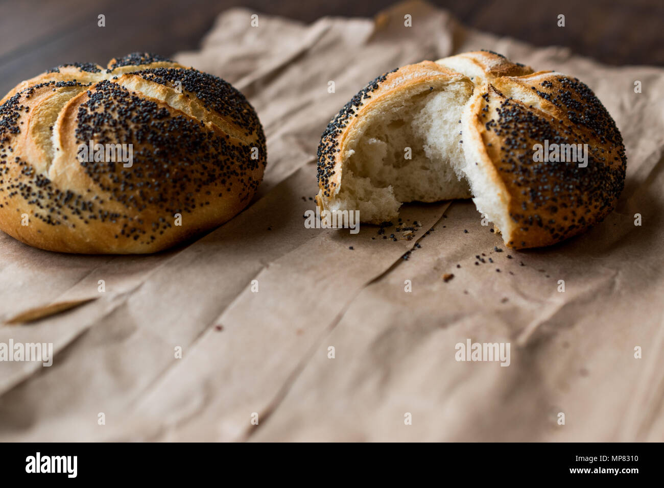 Bitten Bread Kaiser Rolls with Poppy Seeds. Bakery Concept Stock Photo ...
