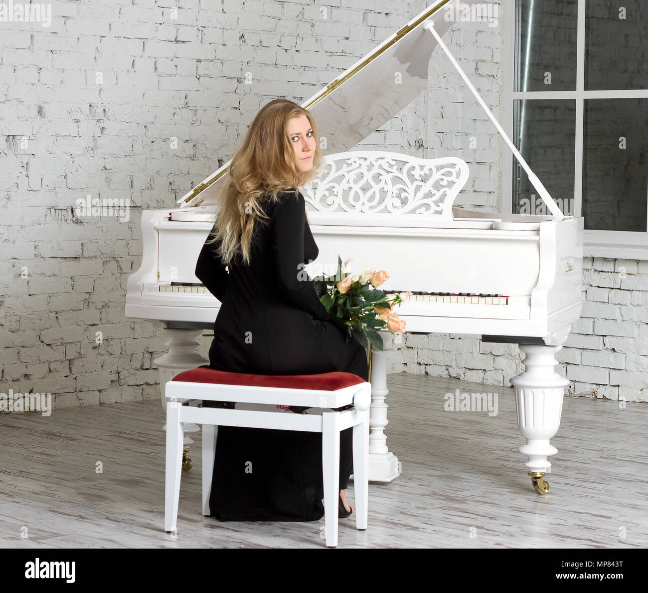 beautiful young woman playing the white piano Stock Photo - Alamy