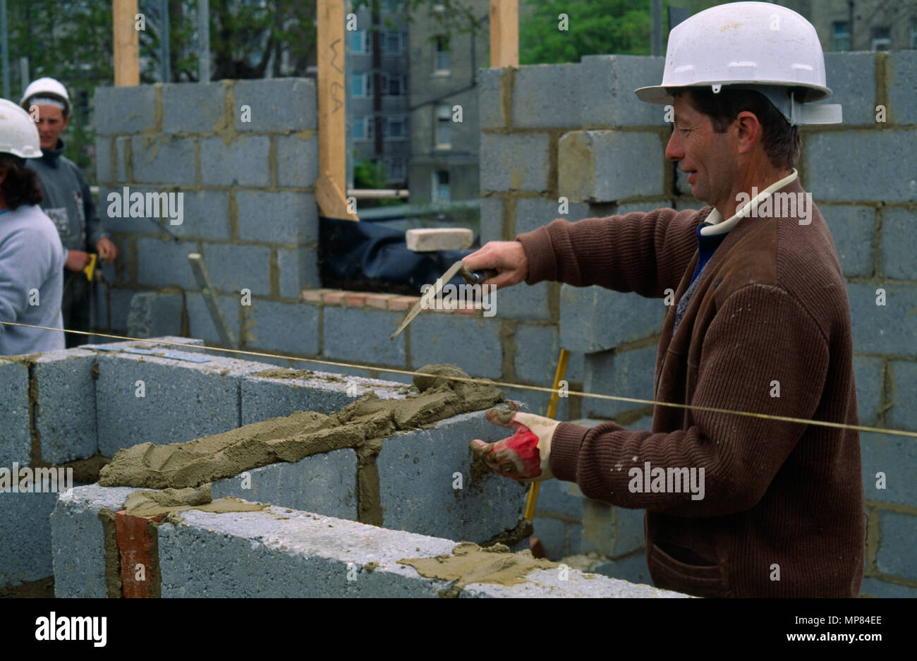 Construction, Bricklayer building house Stock Photo - Alamy