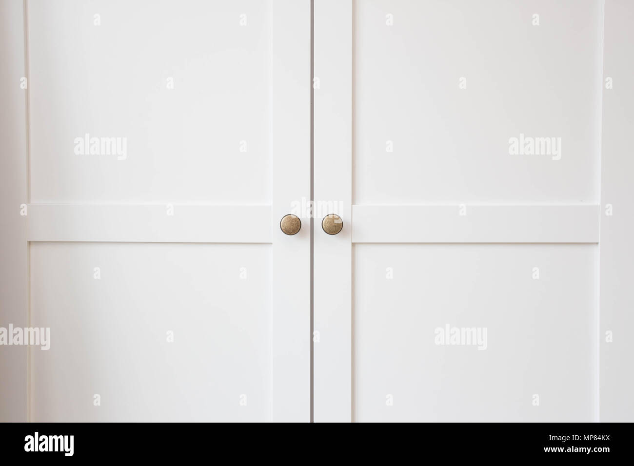 Close-up white cupboard wooden doors Stock Photo - Alamy