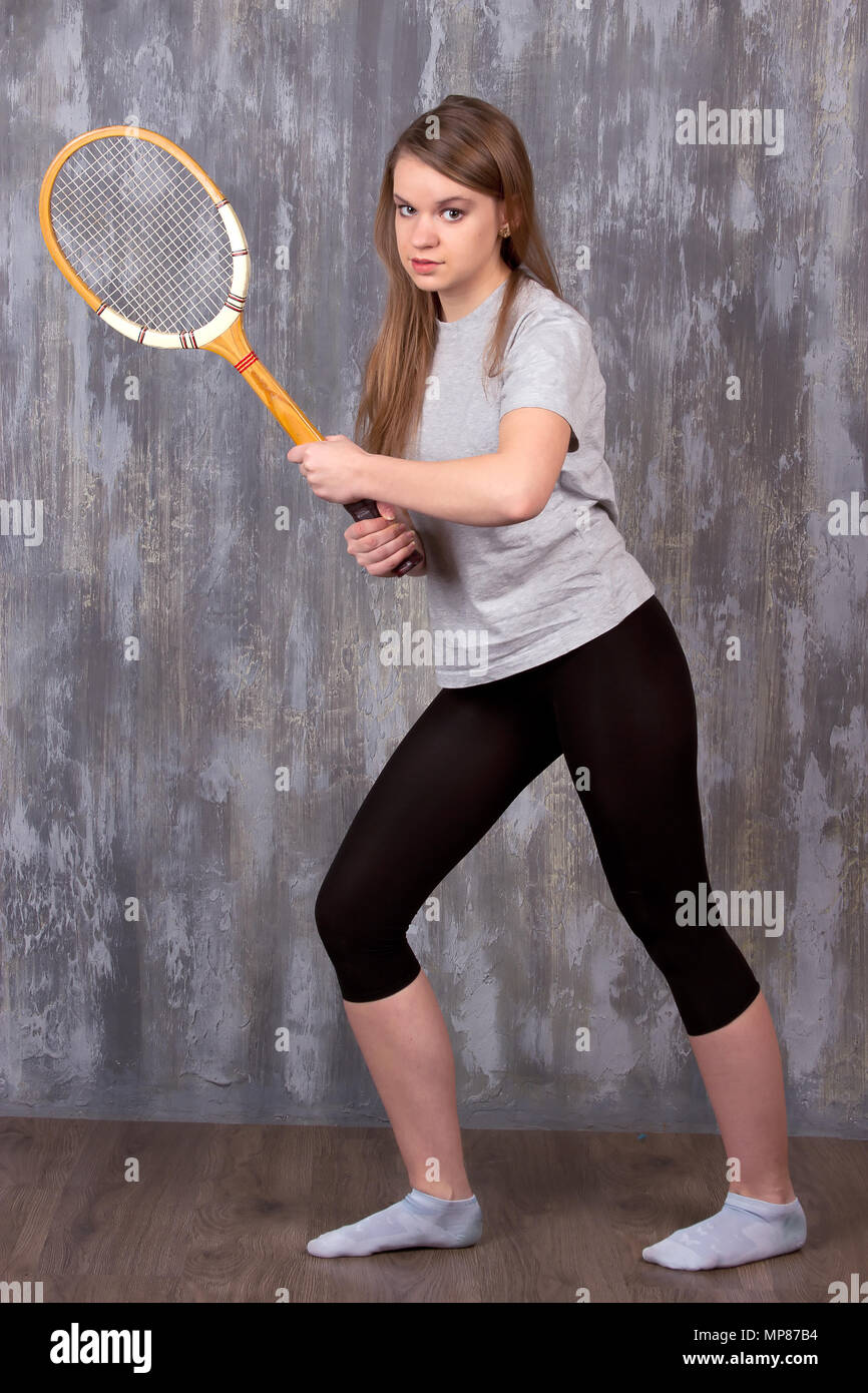 Action portrait of a girl with tennis racket Stock Photo - Alamy