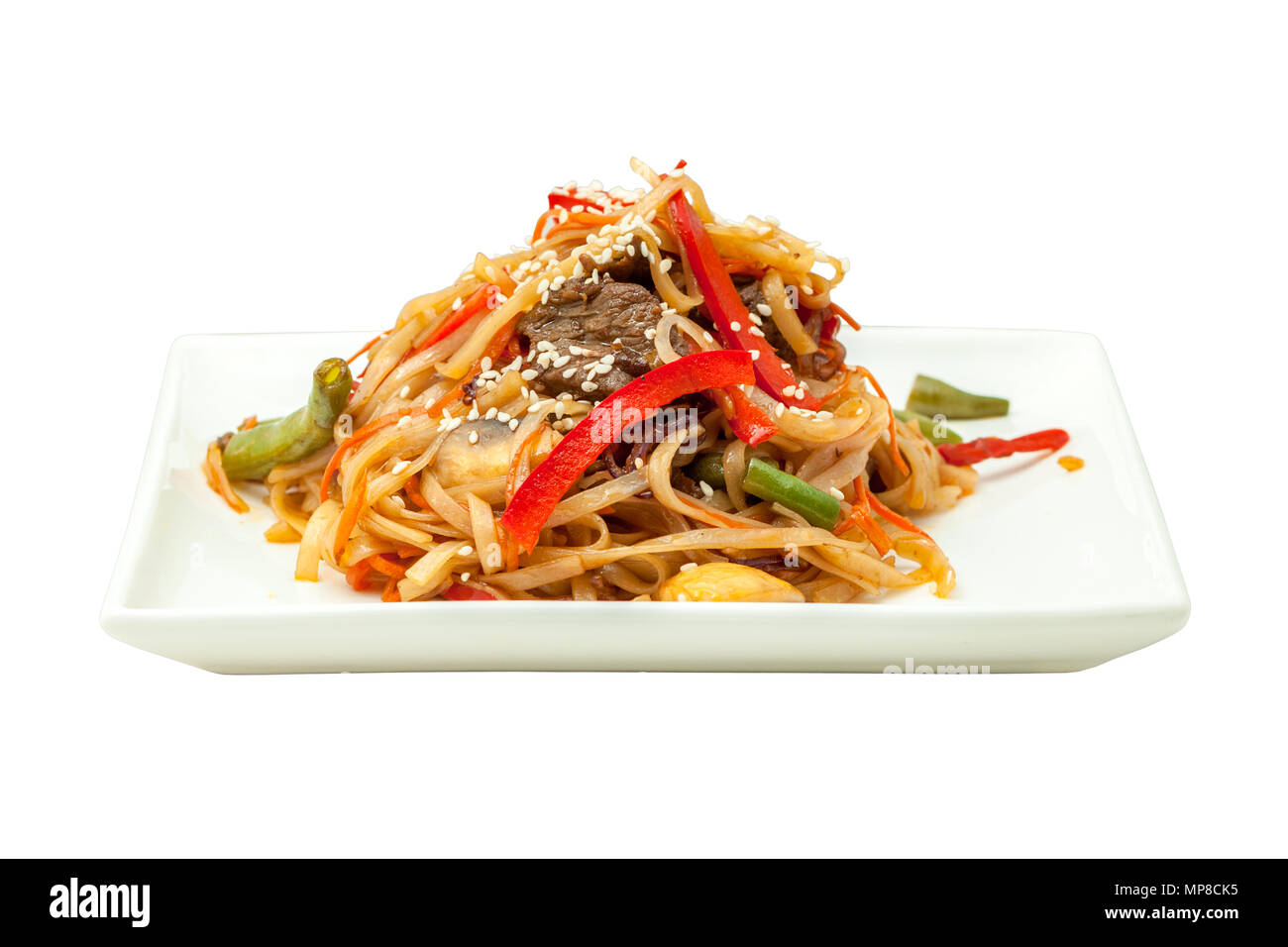 Chinese noodles with beef and vegetables on a square plate isolated ...