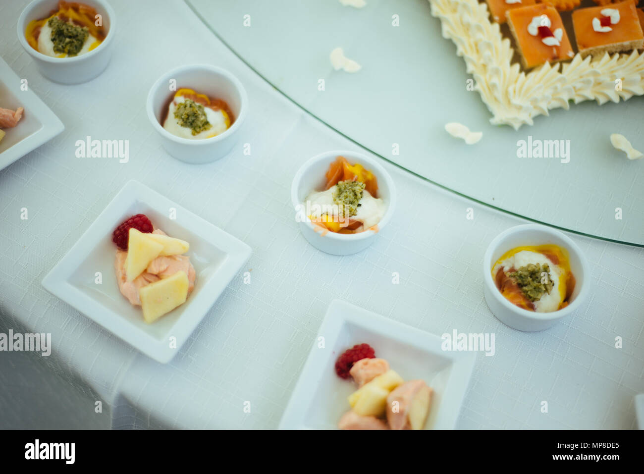table set with plates of canapés for reception and wedding party Stock ...
