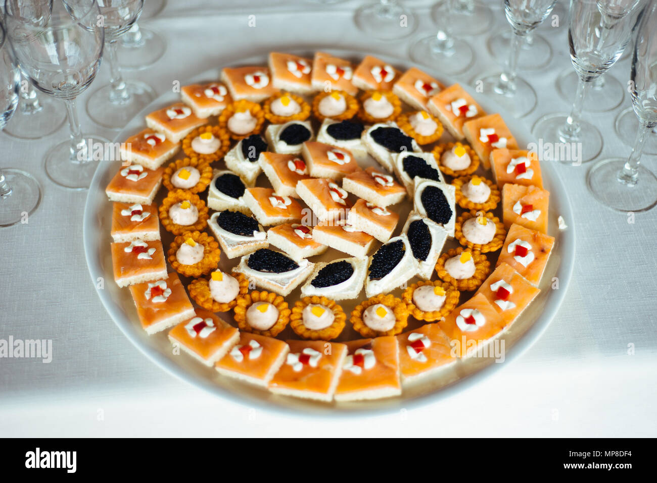 table set with plates of canapés for reception and wedding party Stock ...