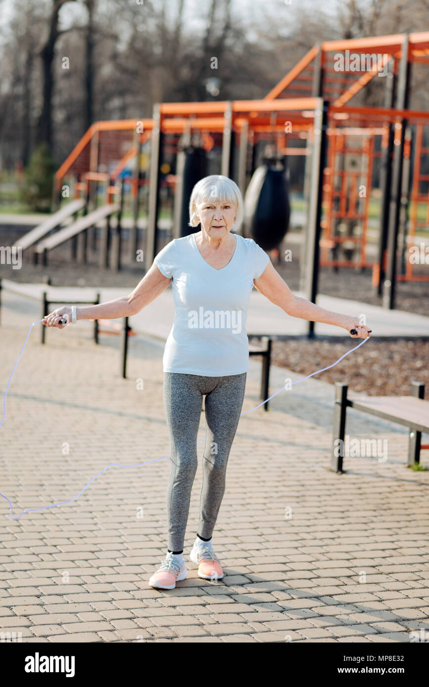 Happy aged woman jumping her rope Stock Photo - Alamy