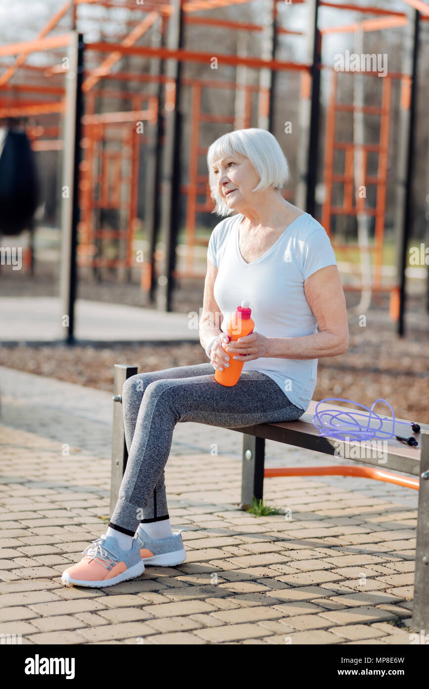 Happy woman relaxing on the bench Stock Photo - Alamy