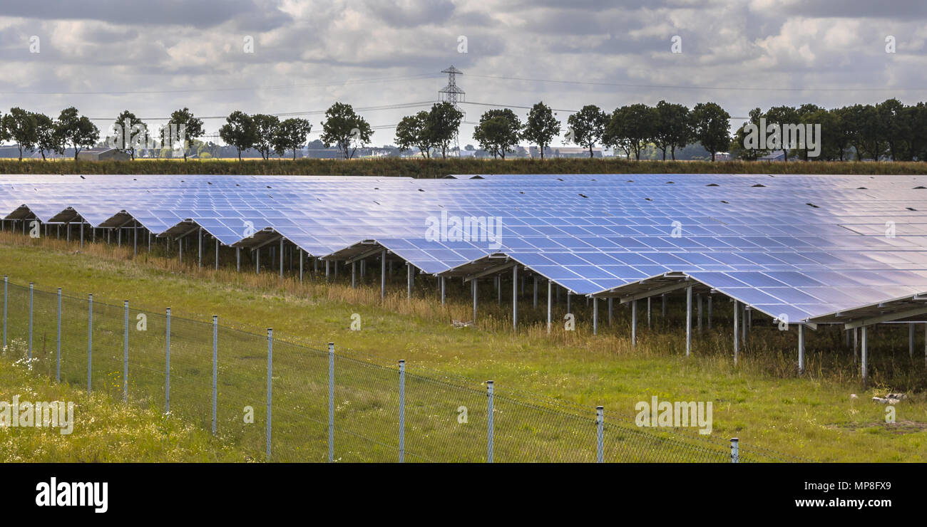 solar panels of a photovoltaic system in industrial area on summer day ...
