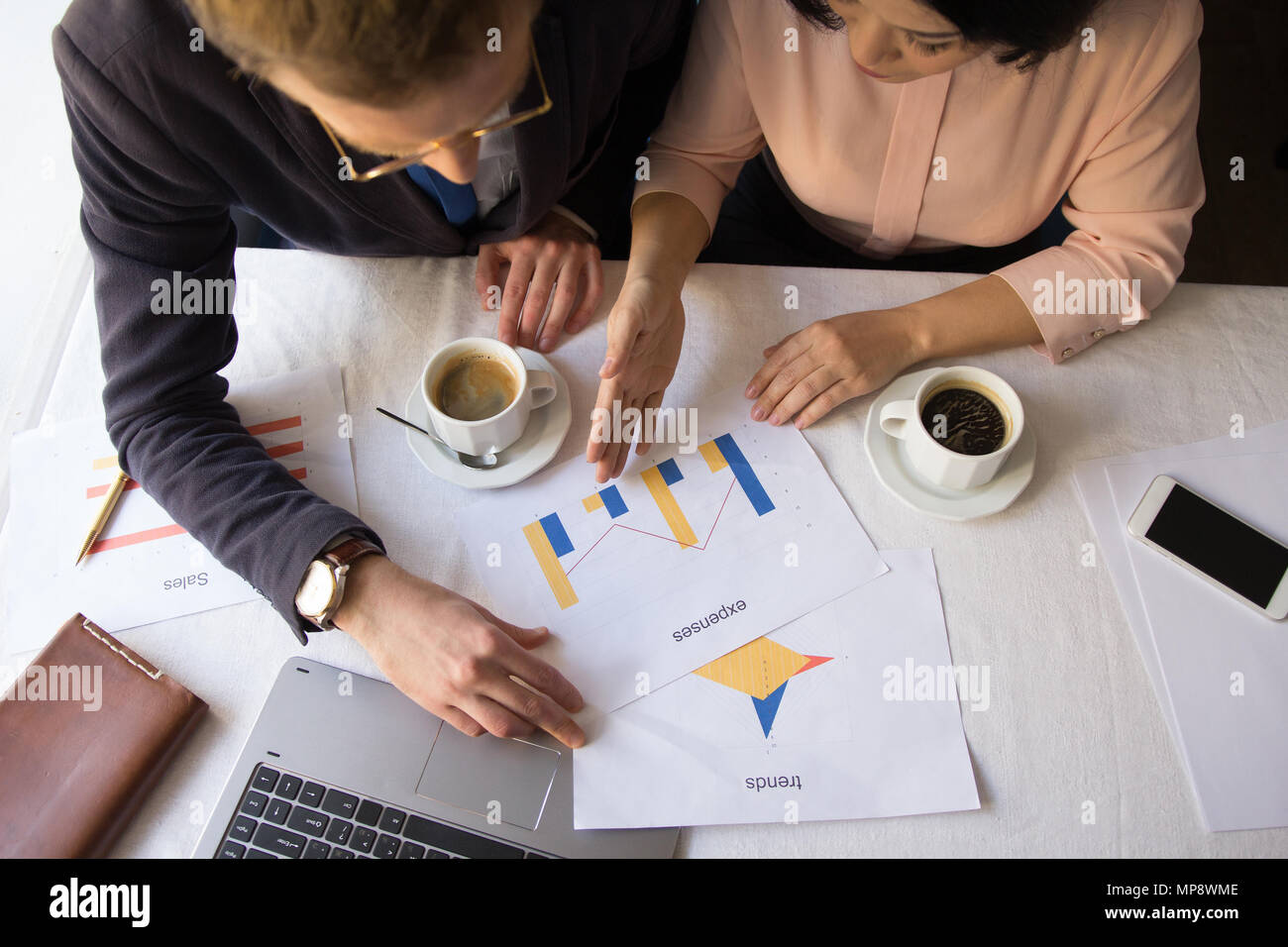 Two partners working together and having coffee Stock Photo - Alamy