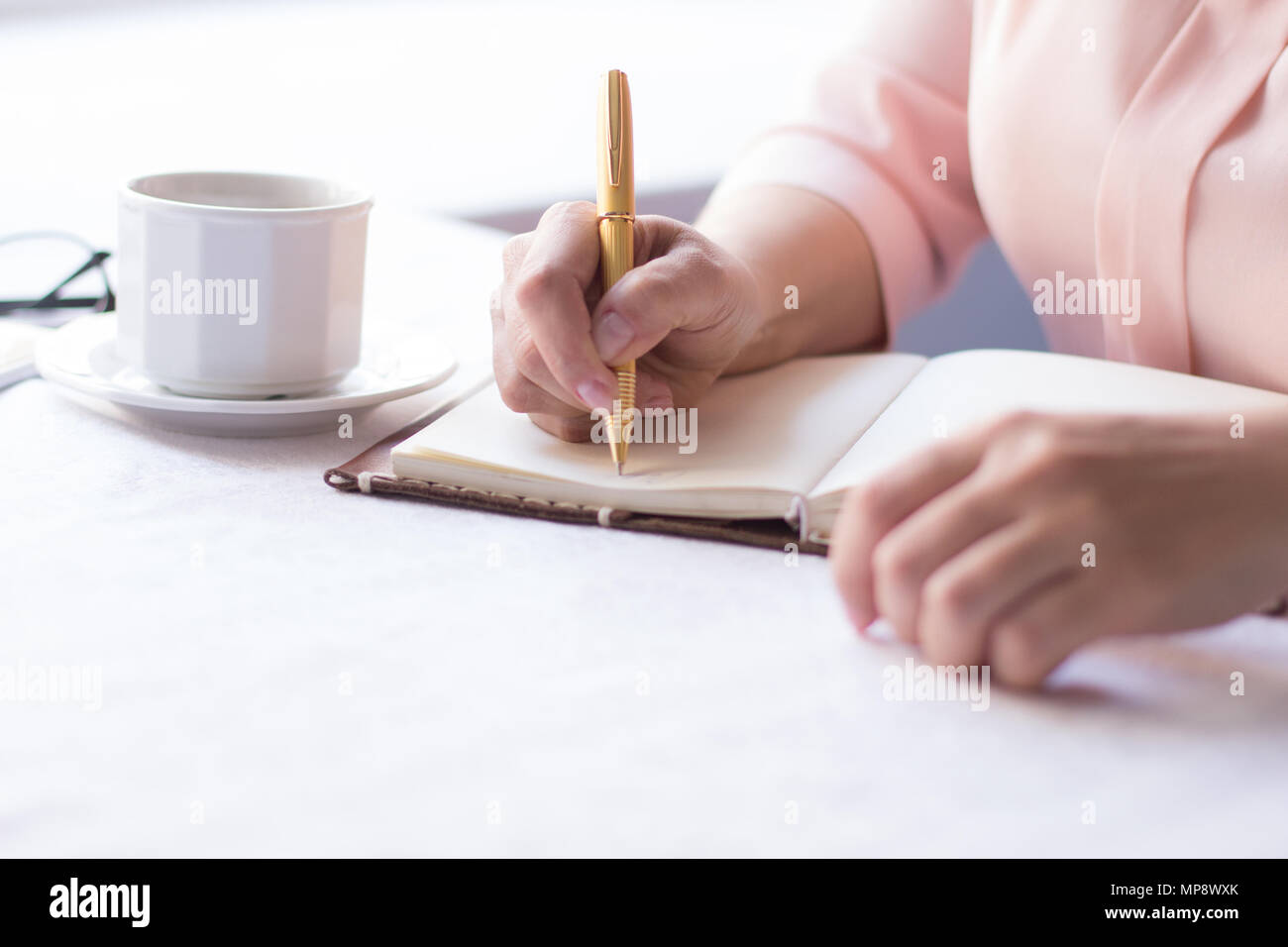 Beautiful young woman making notes Stock Photo - Alamy