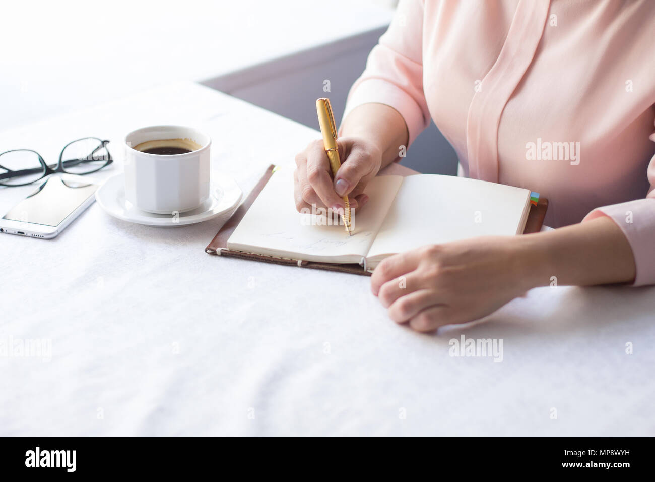 Beautiful young woman making notes Stock Photo - Alamy