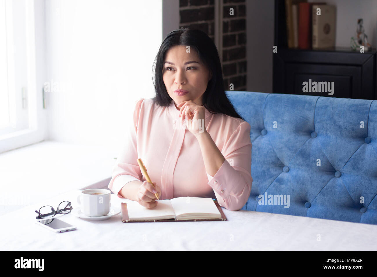 Beautiful young woman making notes Stock Photo - Alamy