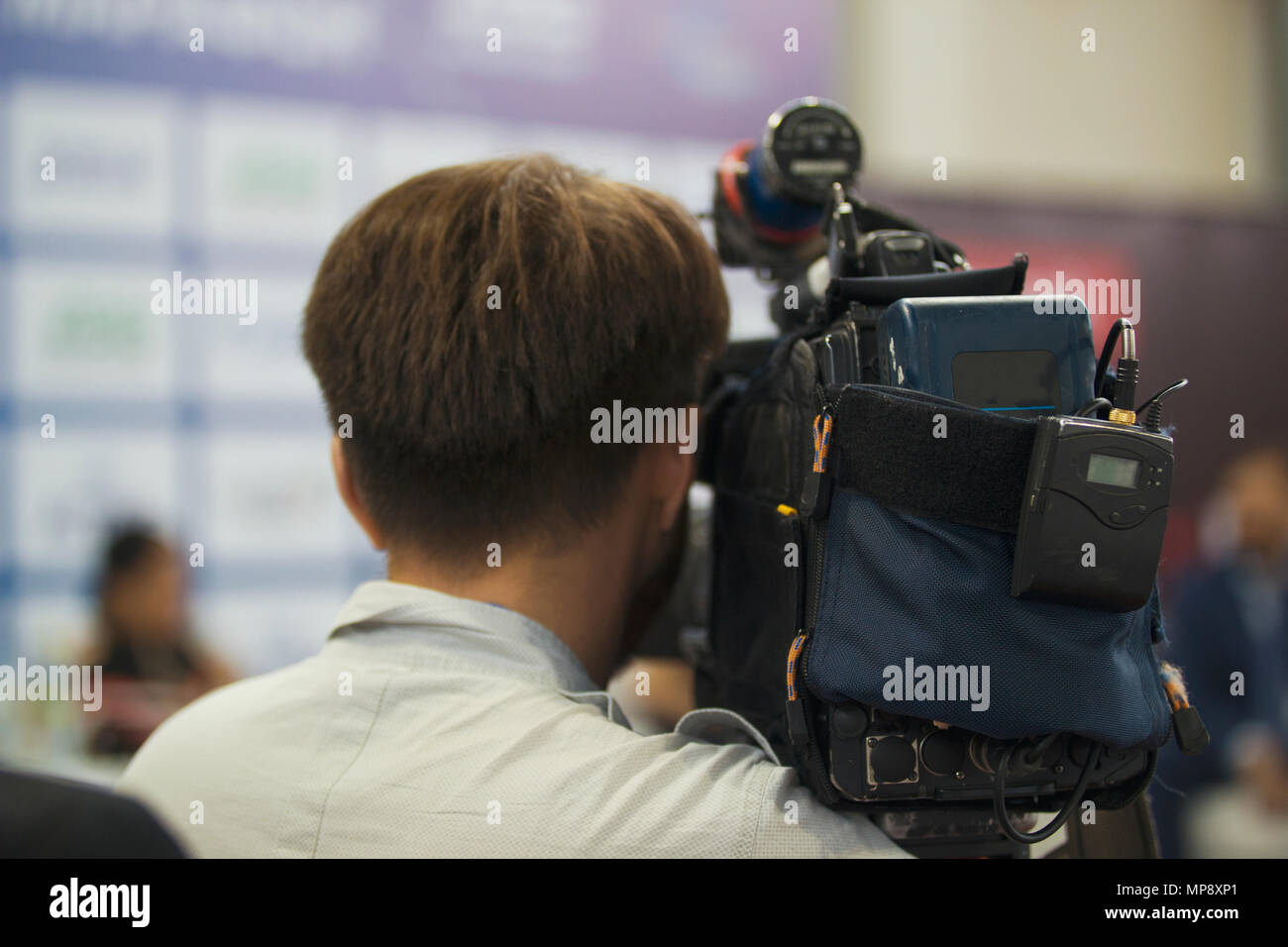 The young male cameraman doing the filming Stock Photo - Alamy