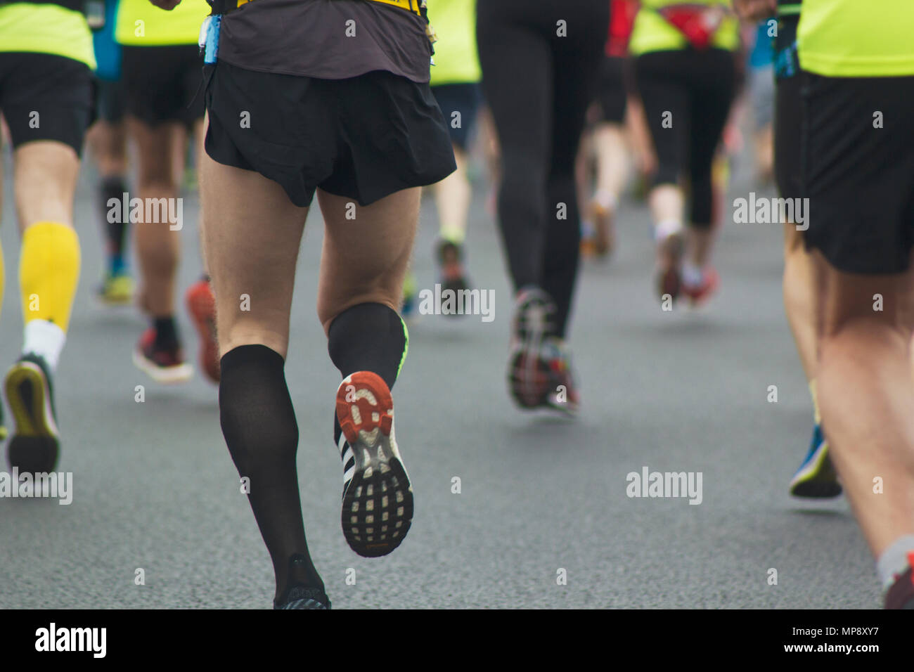 Athletes, runners at the marathon, athletes ' legs rear view Stock ...
