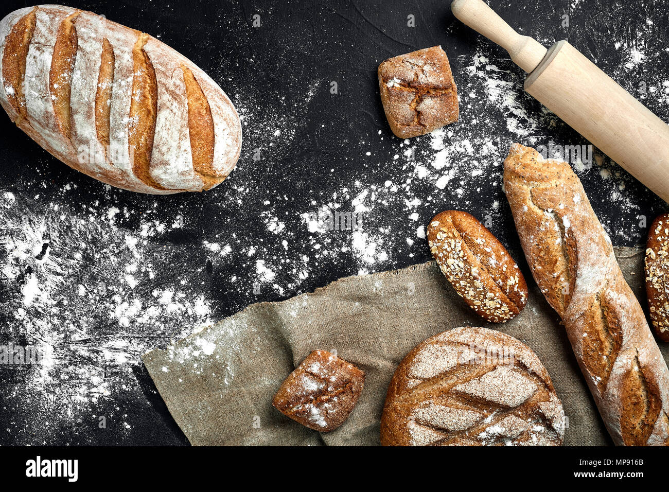 Mixed breads on black table. Top view with copy space Stock Photo - Alamy