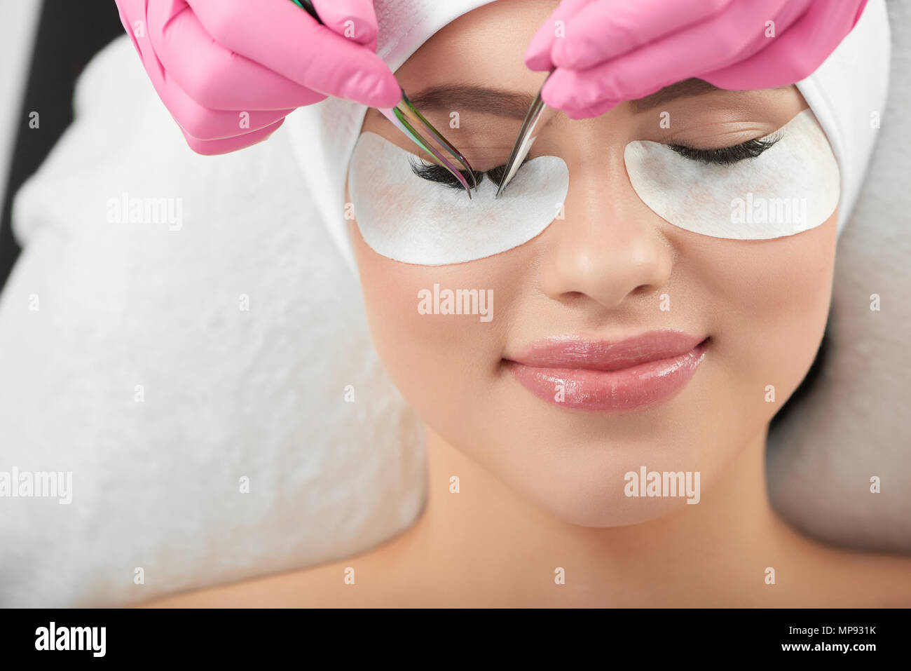 Professional photo of smiling model lying during lasmkaing process ...