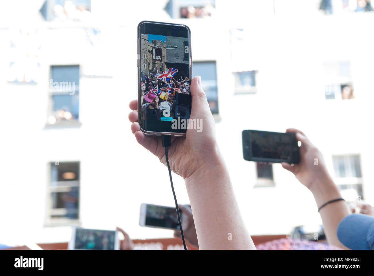 People in crowd with mobile devises using iphones to record events ...