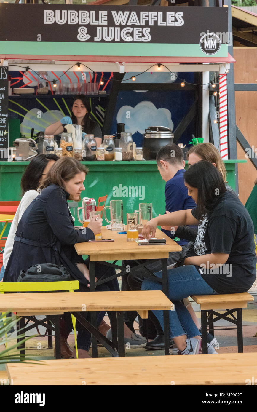 Some young people and friends enjoying getting together for a meal out ...