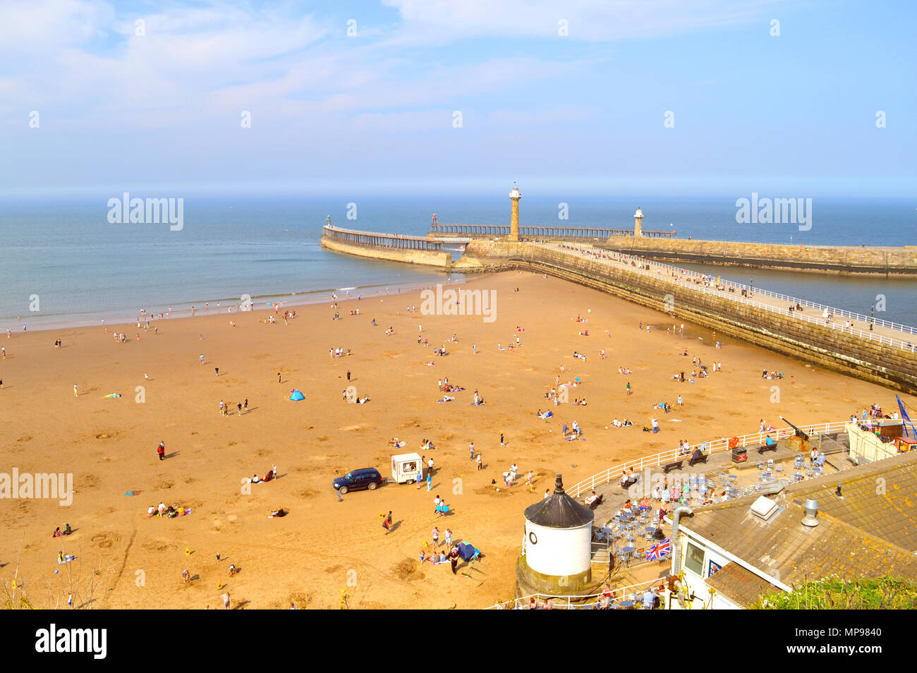 Tourists on Whitby beach West Cliff in North Yorkshire Stock Photo - Alamy