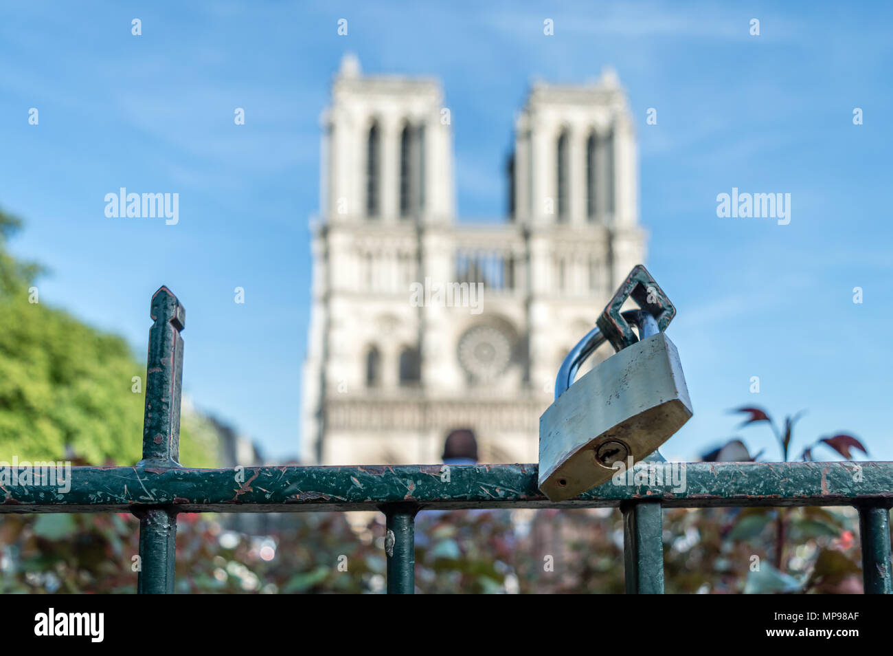 A lock on a metal fence next to the Notre Dame Cathedral in Paris Stock ...