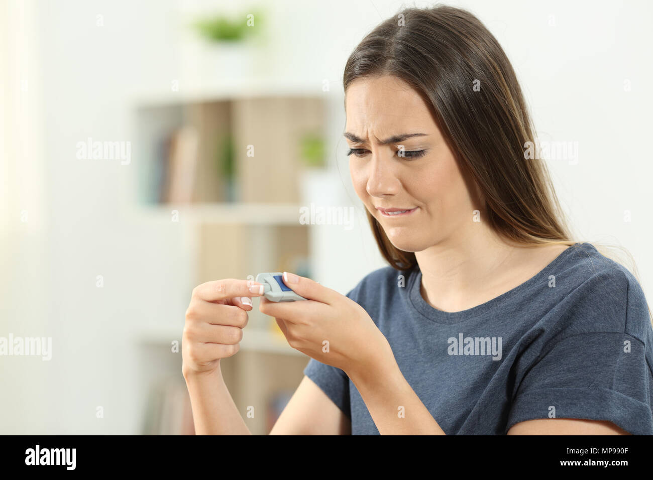 Diabetic girl checking blood sugar level with a glucometer Stock Photo ...