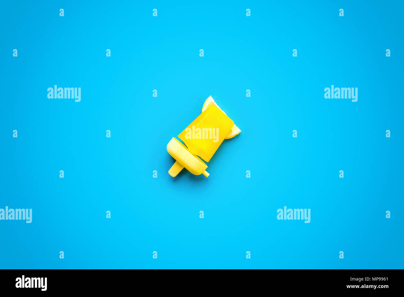 Homemade yellow lemon popsicle isolated on blue background Stock Photo ...