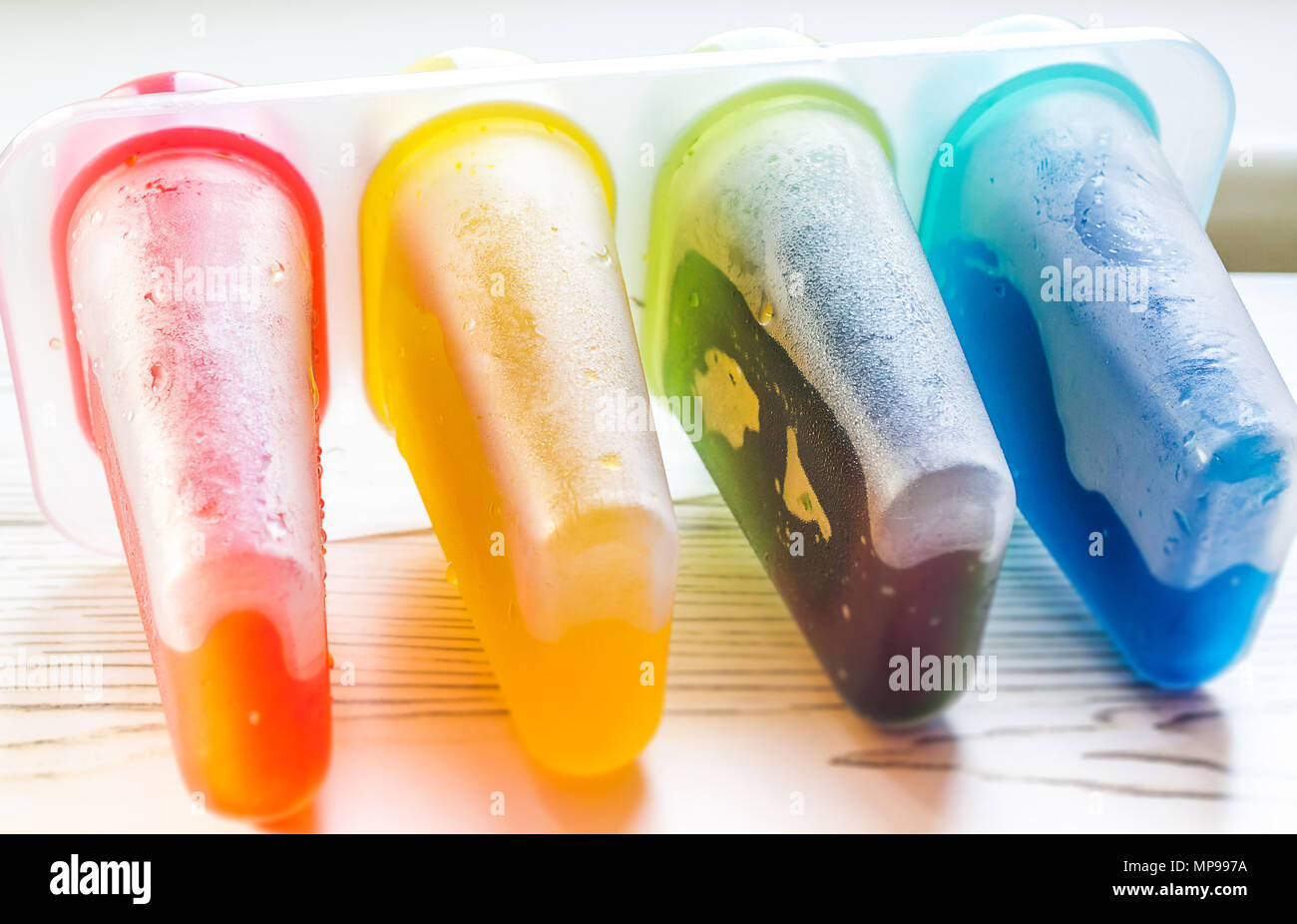 Frozen homemade popsicles in popsicle mold melting Stock Photo - Alamy