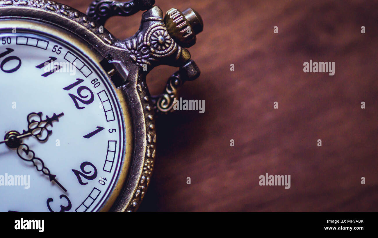 old vintage pocket watch showing time on wooden background Stock Photo ...