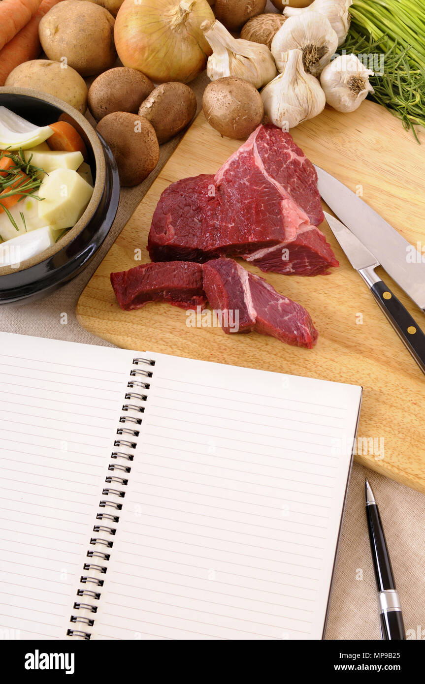 Preparing beef casserole or stew with ingredients and herbs on kitchen ...