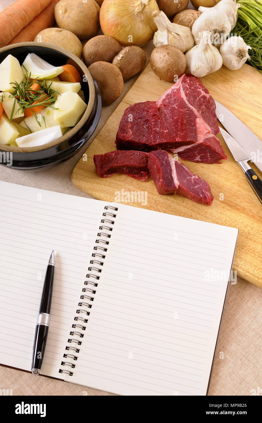 Preparing beef casserole or stew with ingredients and herbs on kitchen ...