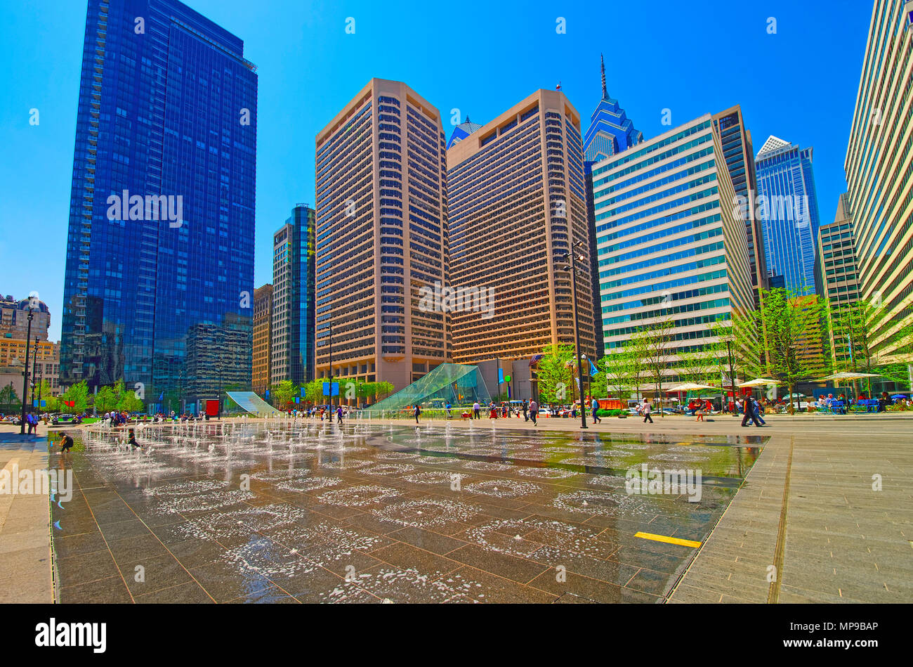 Penn Square and street fountains and skyline of skyscrapers. Tourists ...