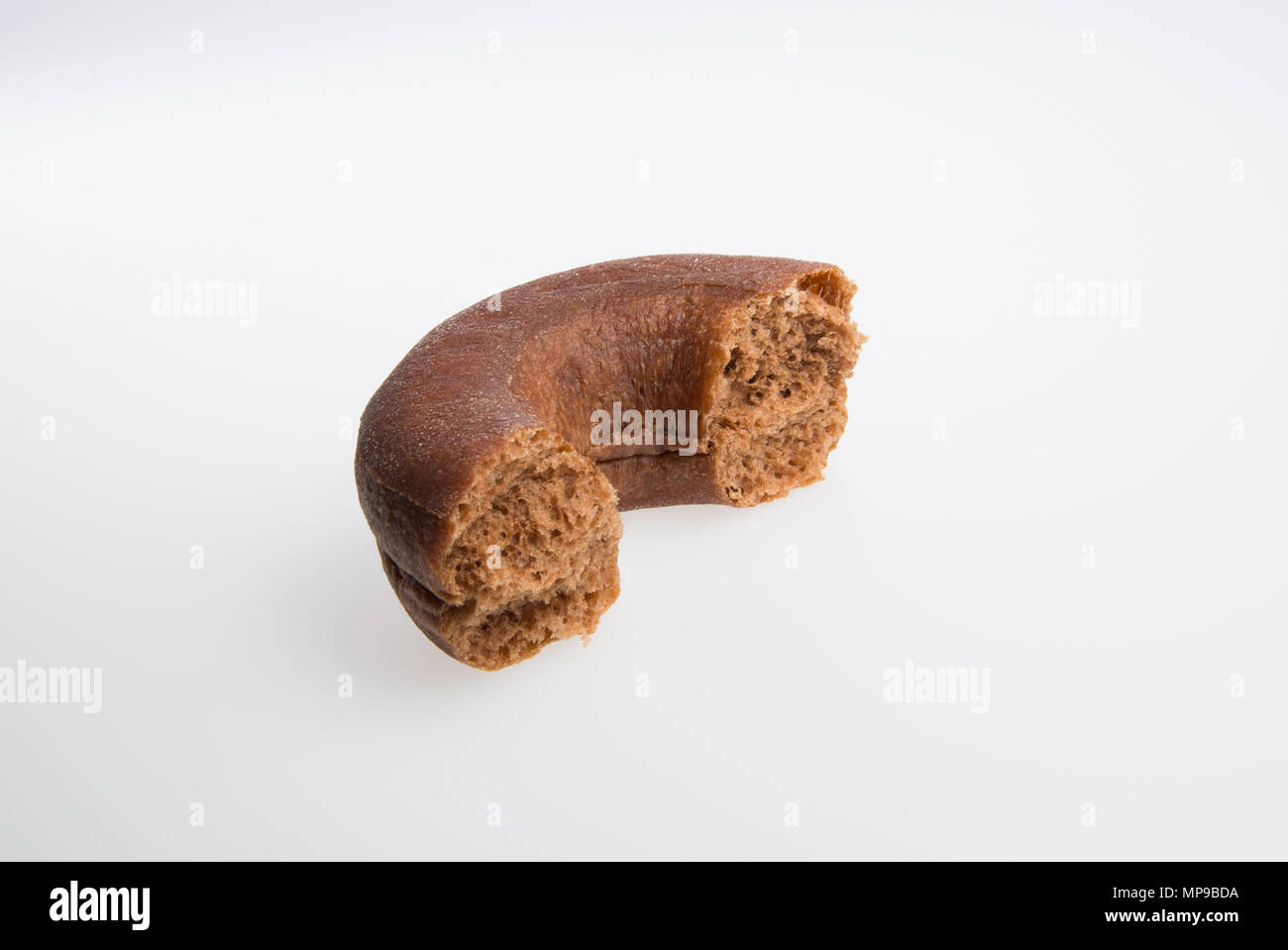 donut or donut with missing bite on a background Stock Photo - Alamy