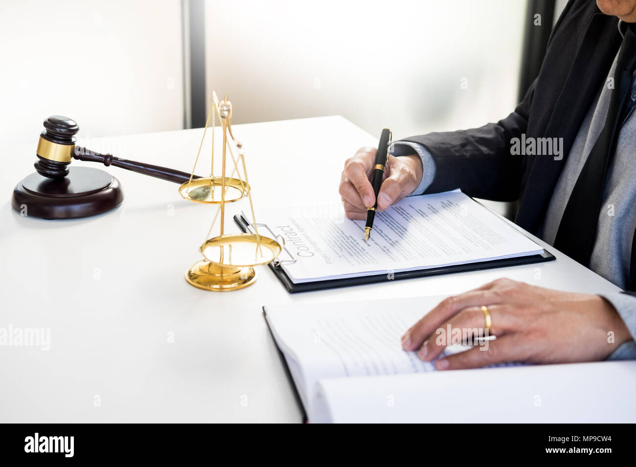 lawyer judge reading and writes the document in court at his desk Stock ...
