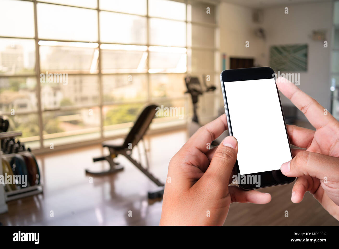 Young man Hand holding smartphone in gym to fitness phone fitness ...