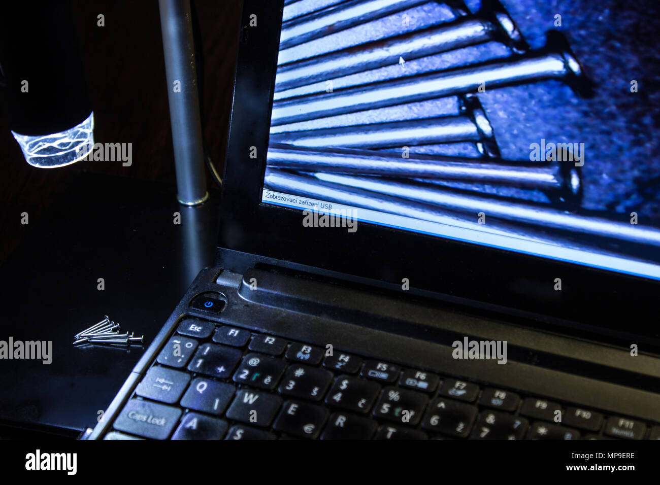 On the left are the nails under the microscope which is illuminated by ...