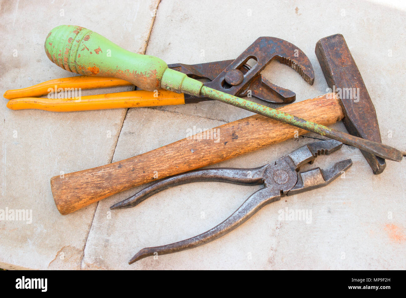Old rusty tools must be replaced with new ones Stock Photo - Alamy