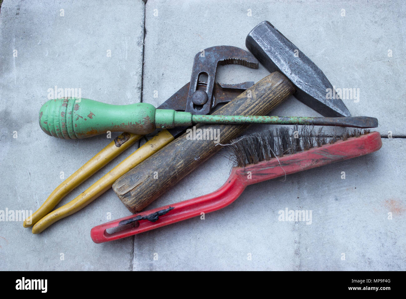 Old rusty tools must be replaced with new ones Stock Photo - Alamy