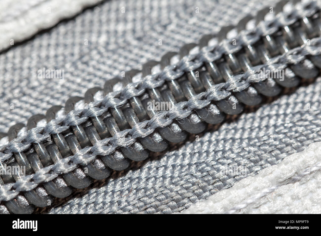grey coloured open zipper Stock Photo - Alamy