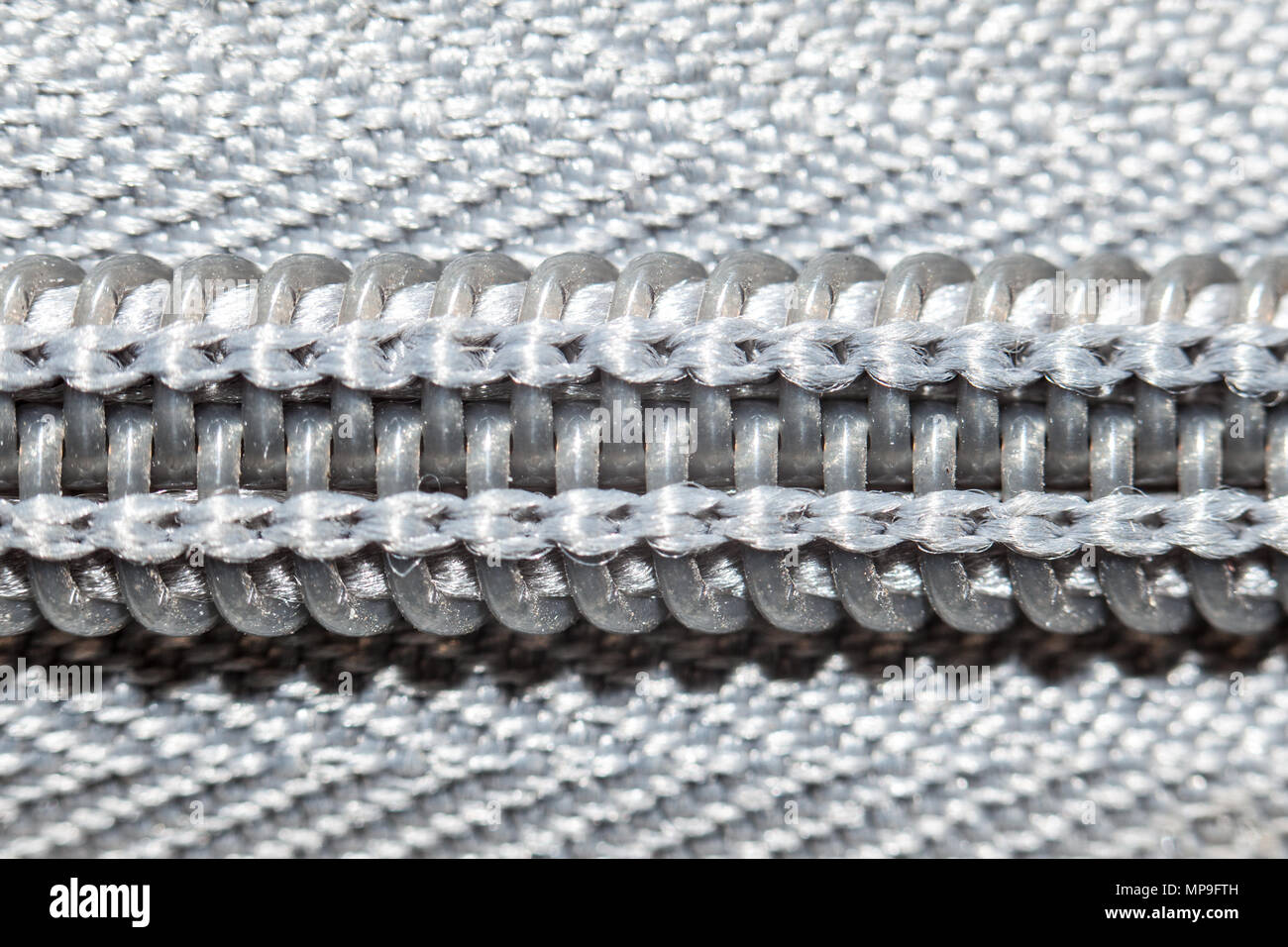 grey coloured open zipper Stock Photo - Alamy