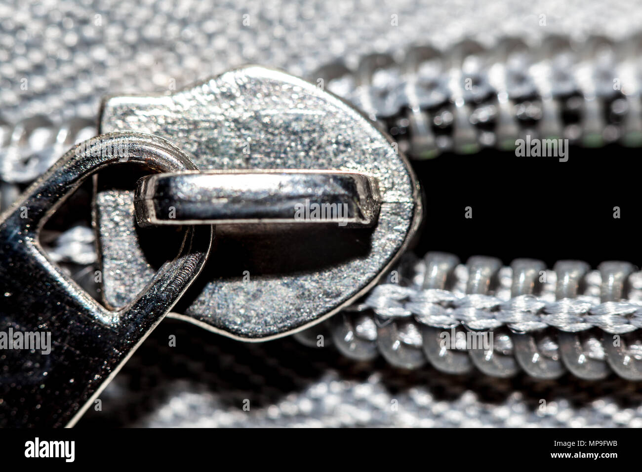 grey coloured open zipper Stock Photo - Alamy