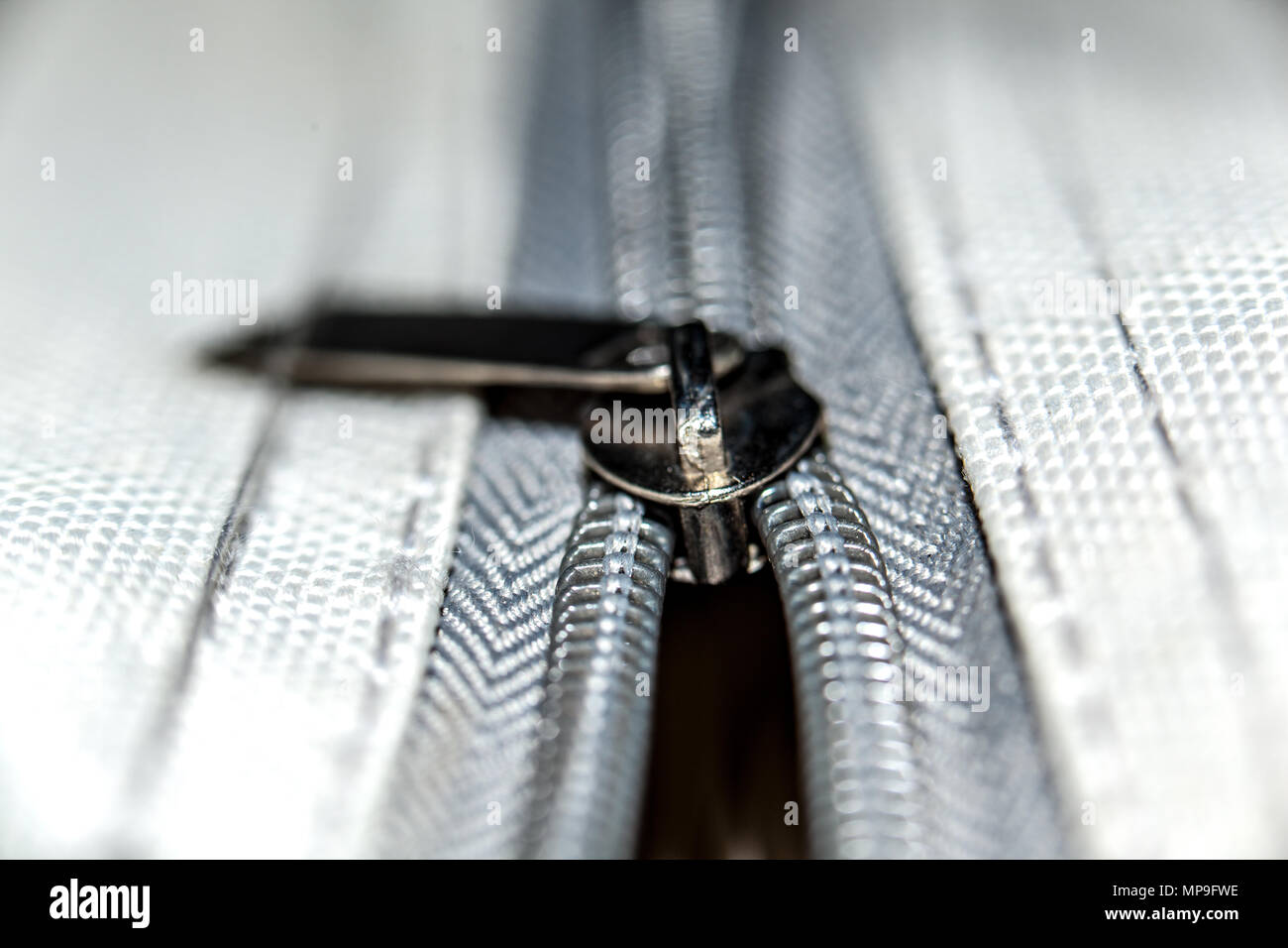grey coloured open zipper Stock Photo - Alamy